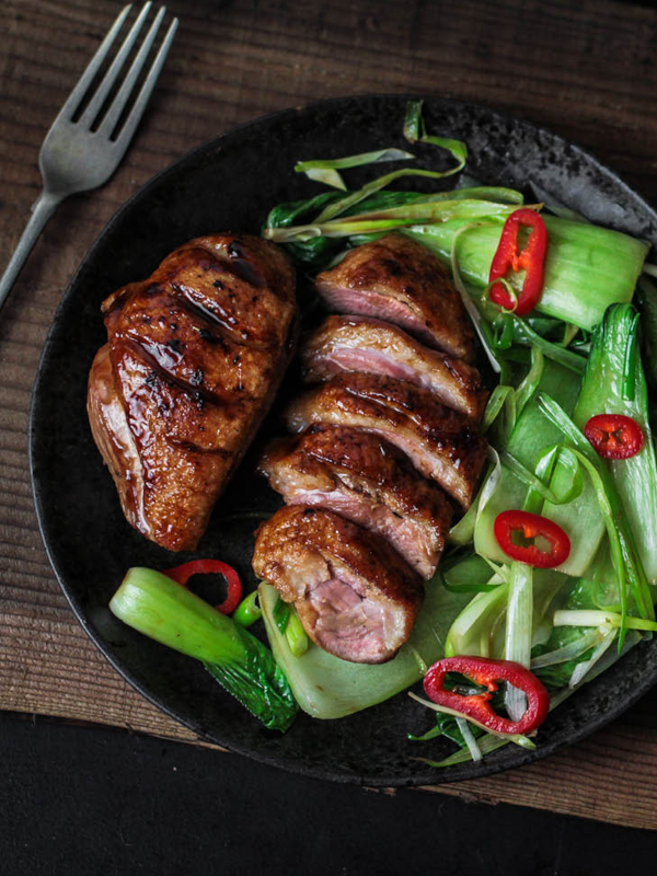 Hoisin duck breast on a bed of pak choi